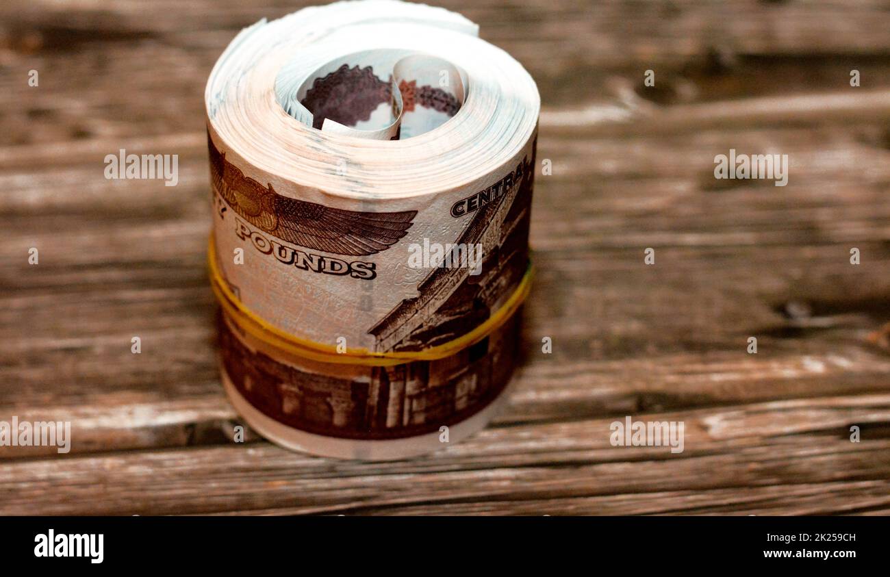 Egypt money roll pounds isolated on wooden background, 50 LE fifty ...
