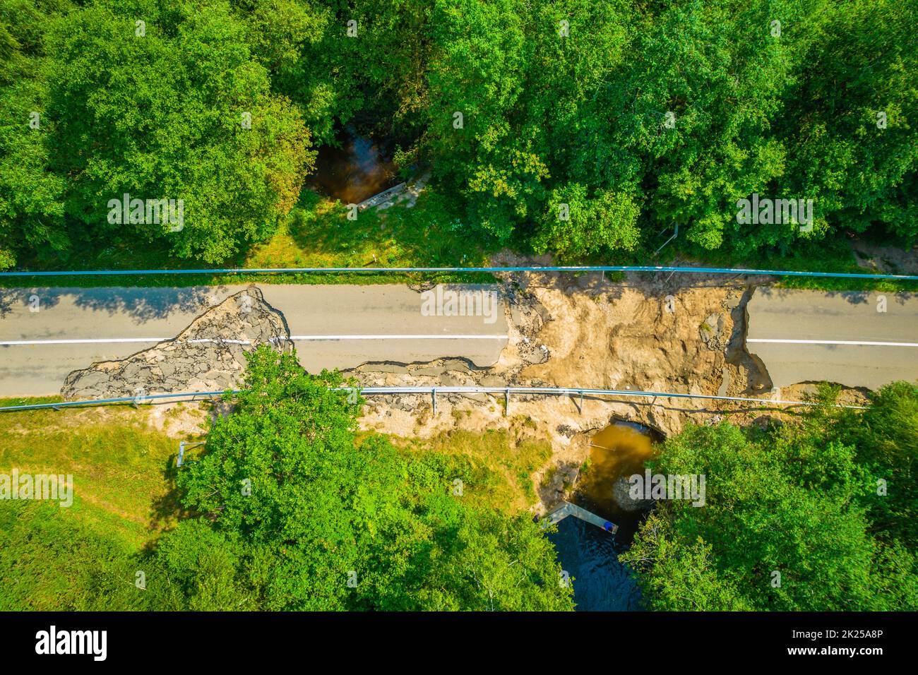 The asphalt road and bridge washed out and destroyed after the heavy ...