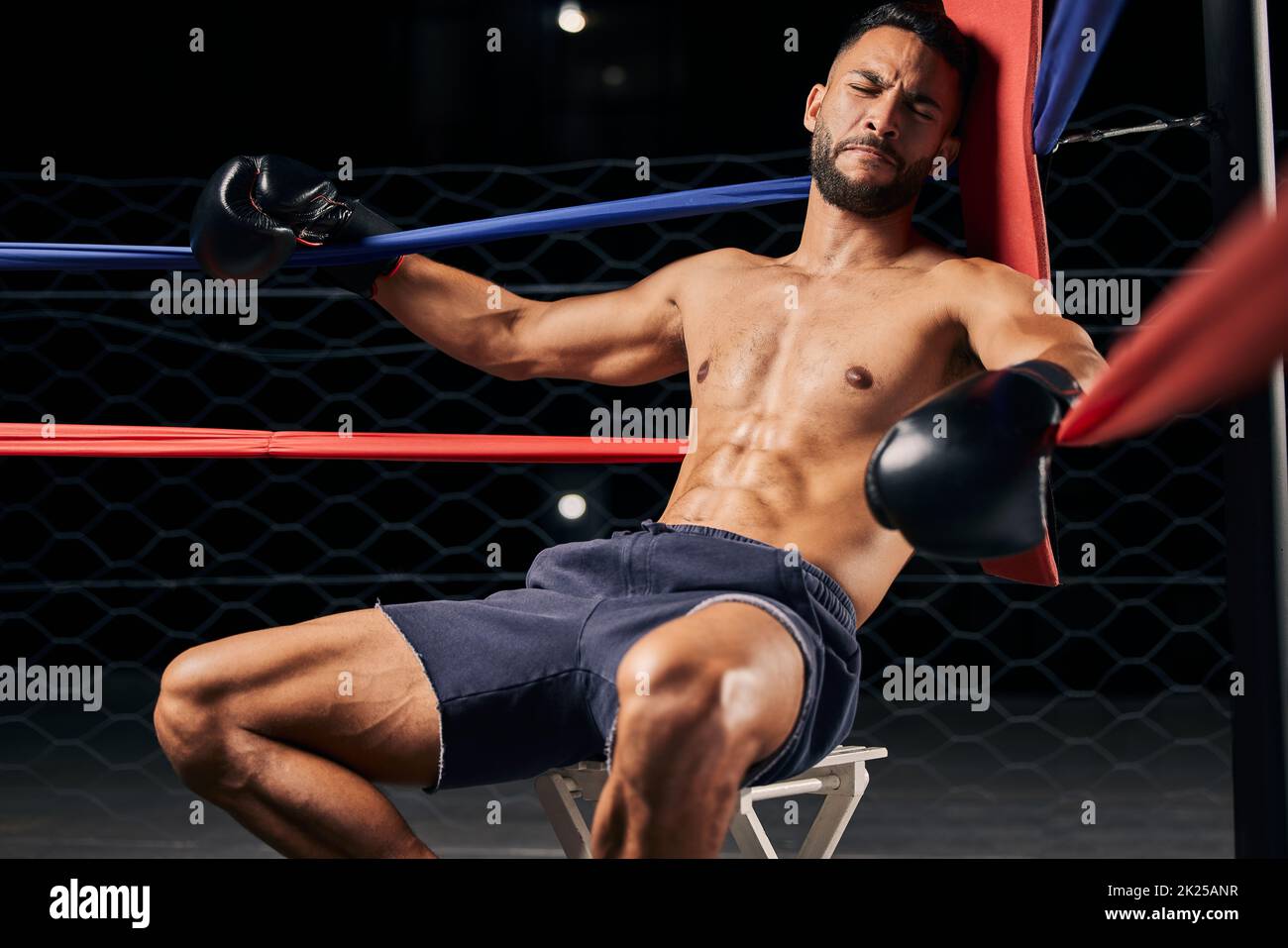 Sports, defeat and boxer tired in a boxing ring after fighting ...