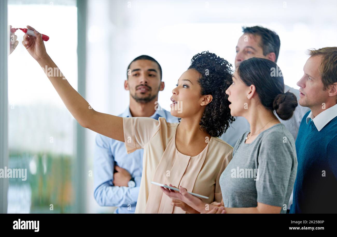 Ideas are flowing. a diverse group of coworkers brainstorming in the ...