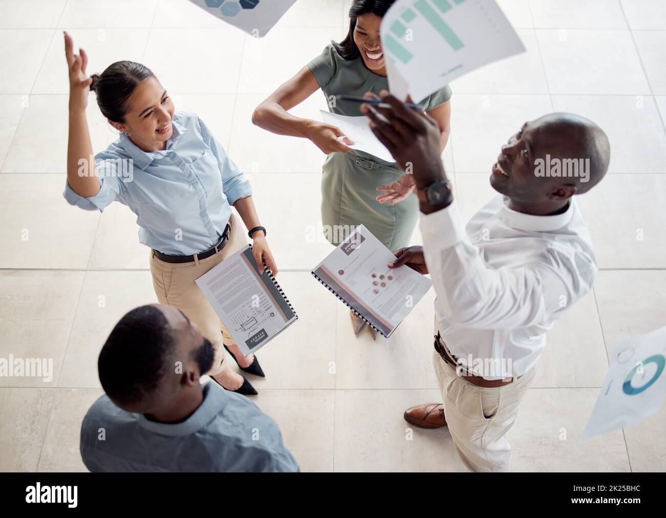 Teamwork, success and paper in the air in the office after a meeting ...