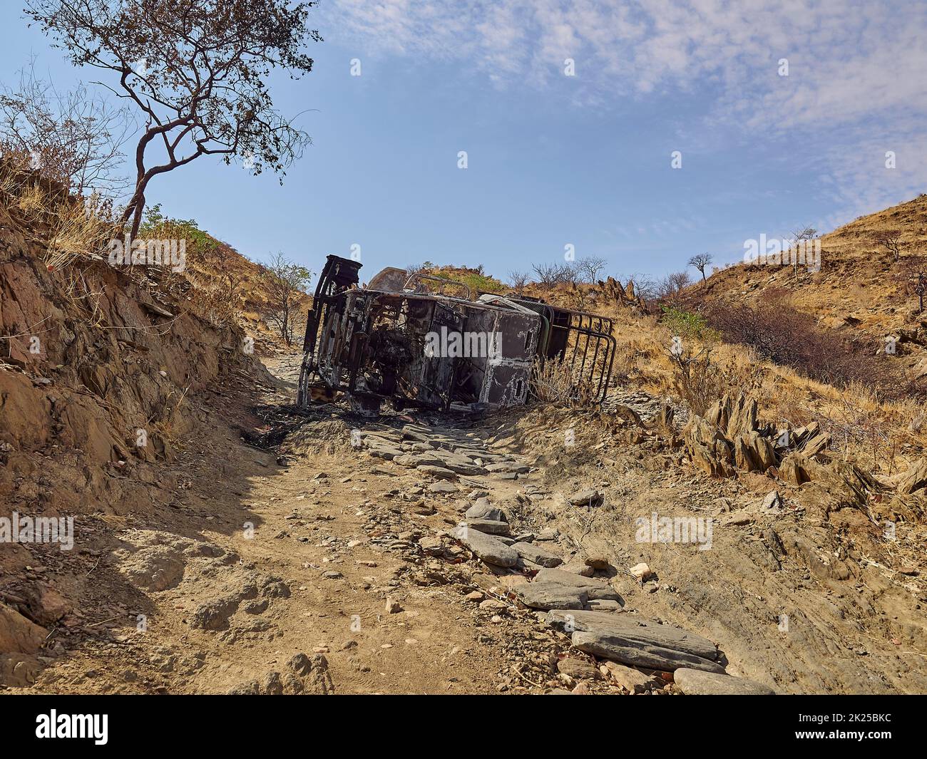 burnt out car wreck lying on its side on steep Jan Joubert mountain ...