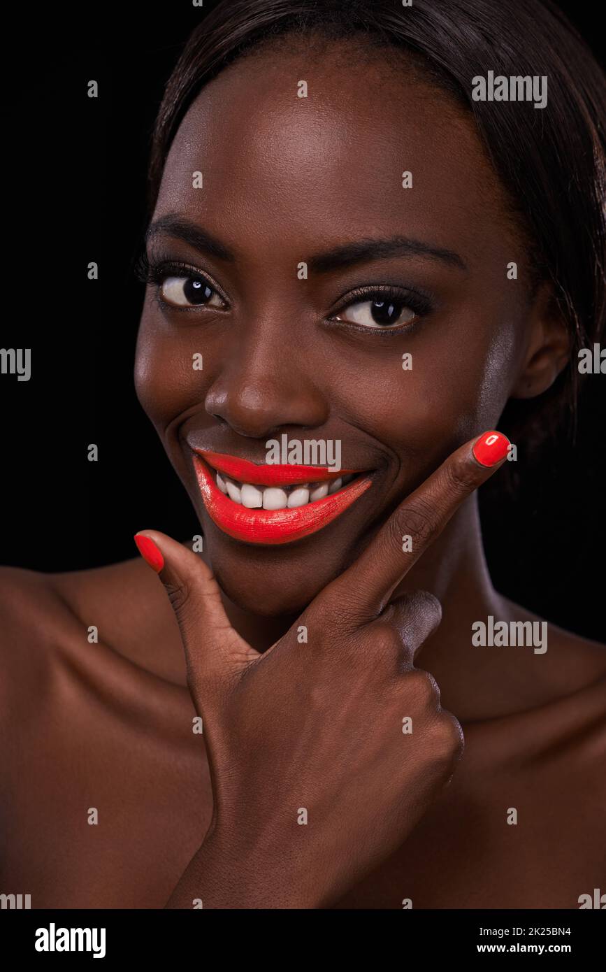 Drawing attention to her smile. Cropped view of an attractive african ...