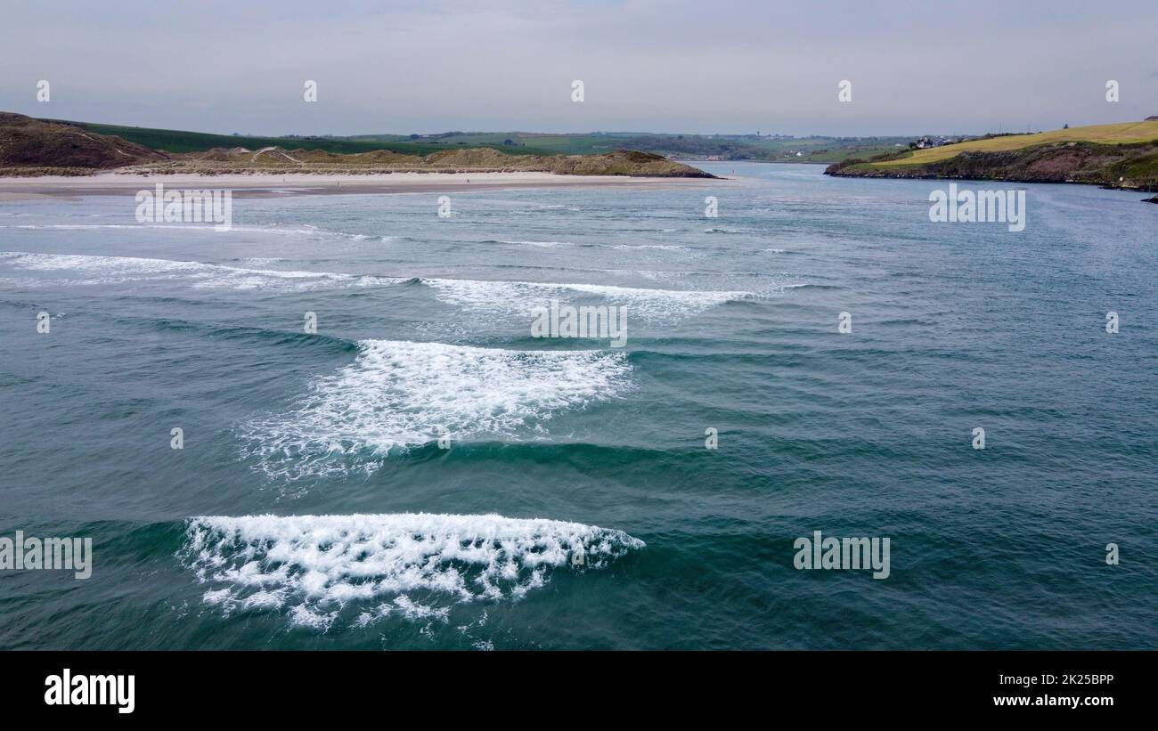 View of Inchydoney beach from the sea at high tide. Beautiful sea waves ...