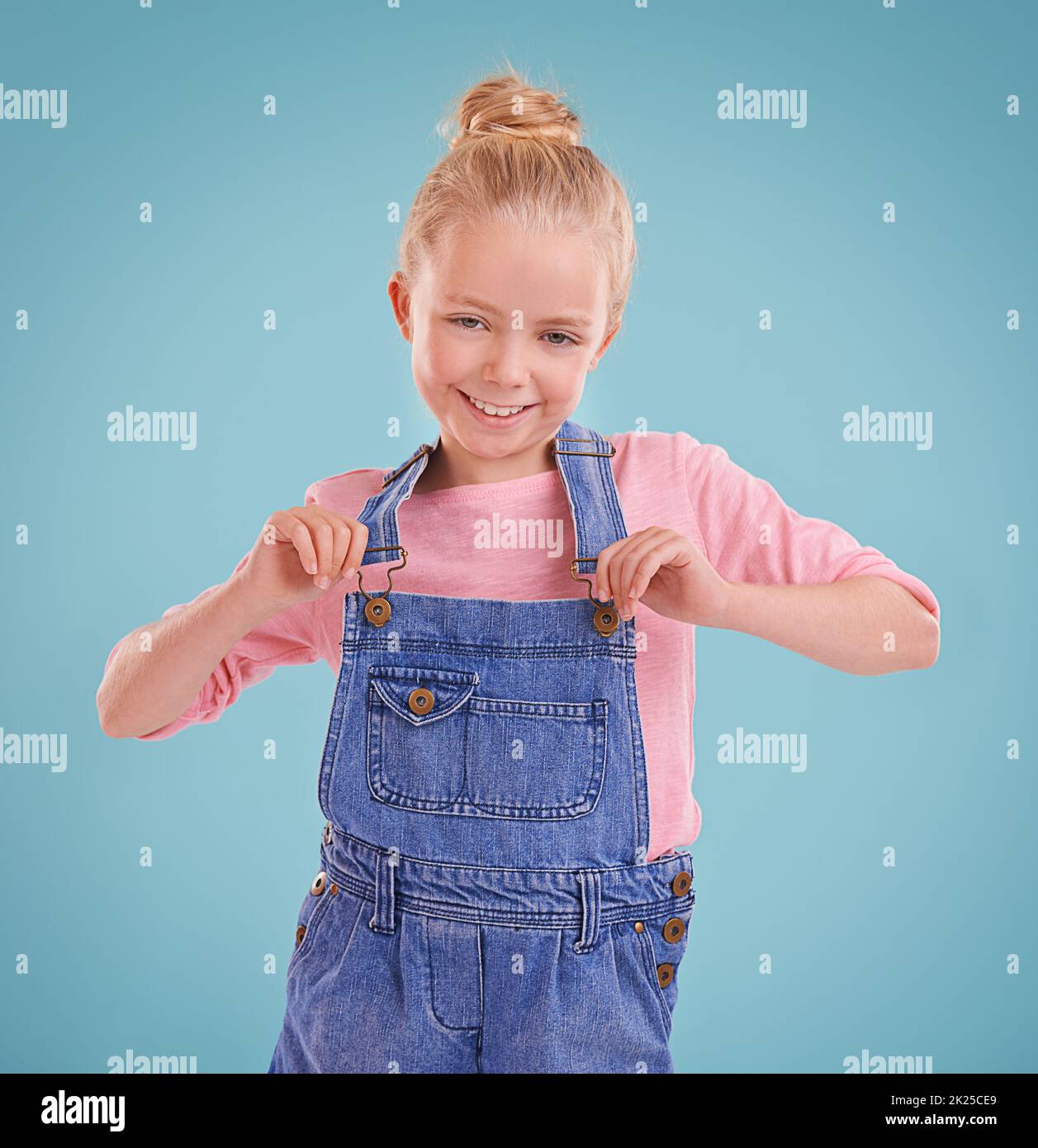 Shes such a cutie. a cute blonde girl isolated on a blue background ...