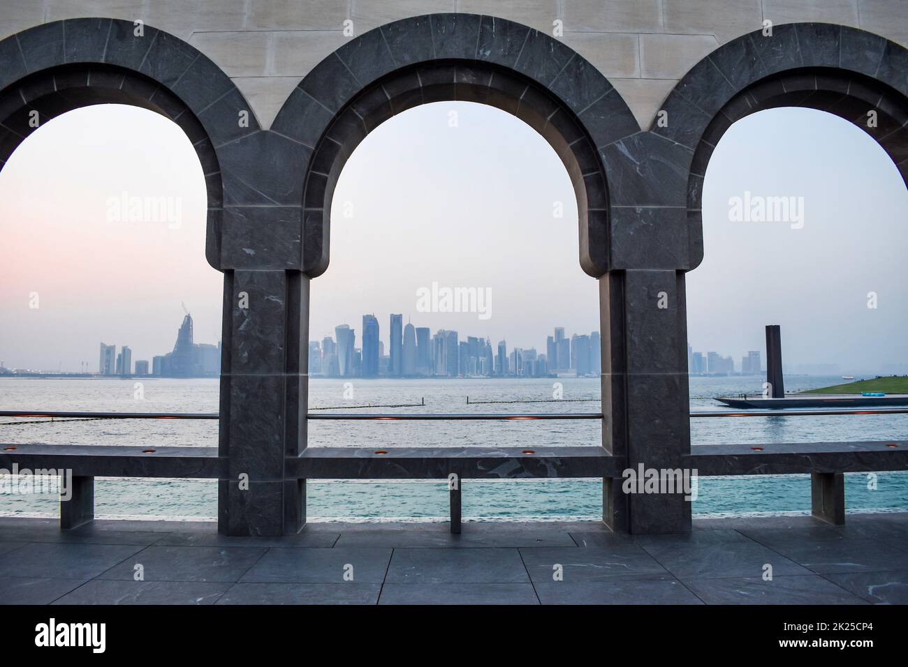 Beautiful view of the sea and Doha skyline, seen through the arched ...