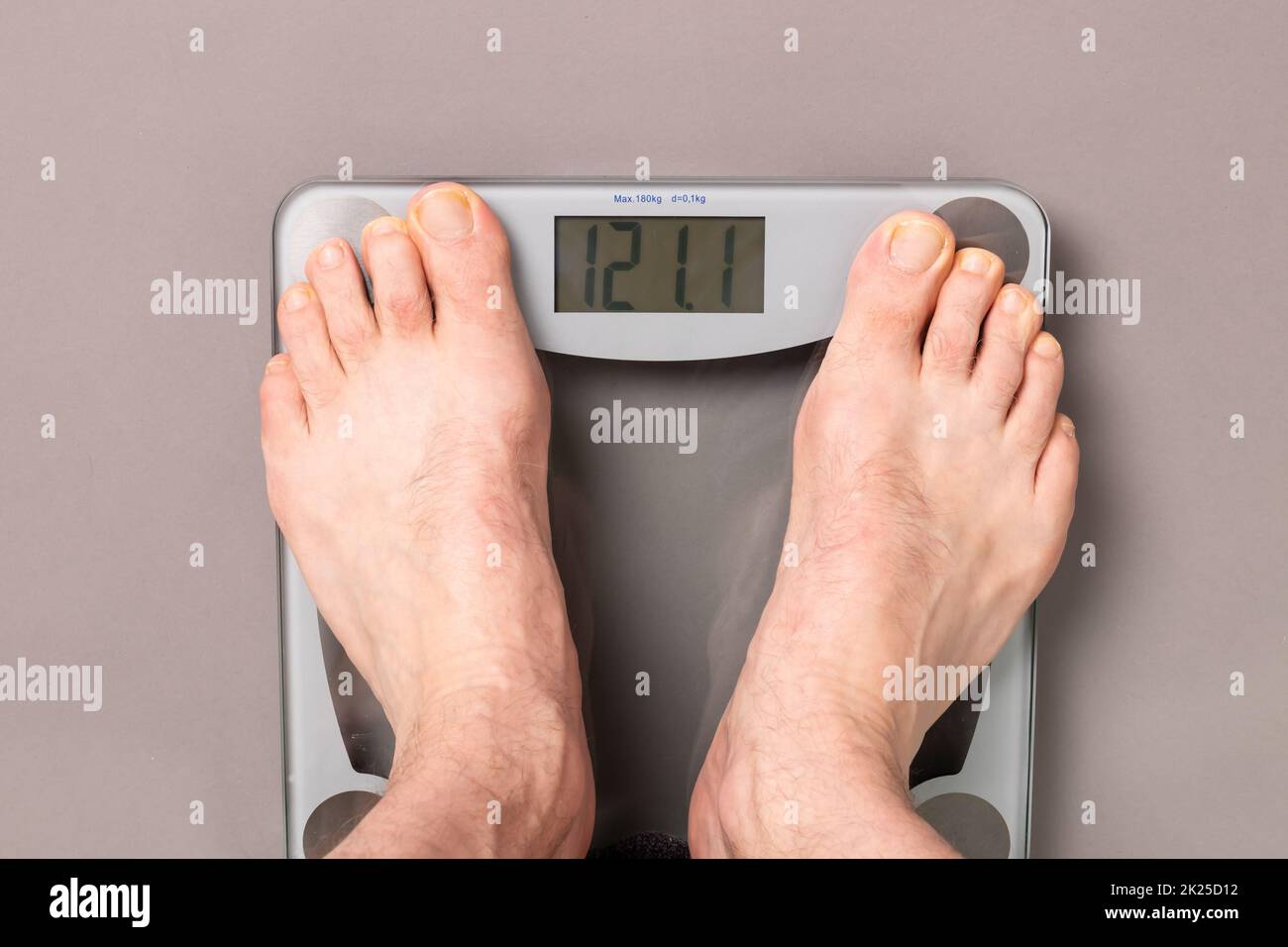 Bathroom scales indicate excess weight Stock Photo - Alamy