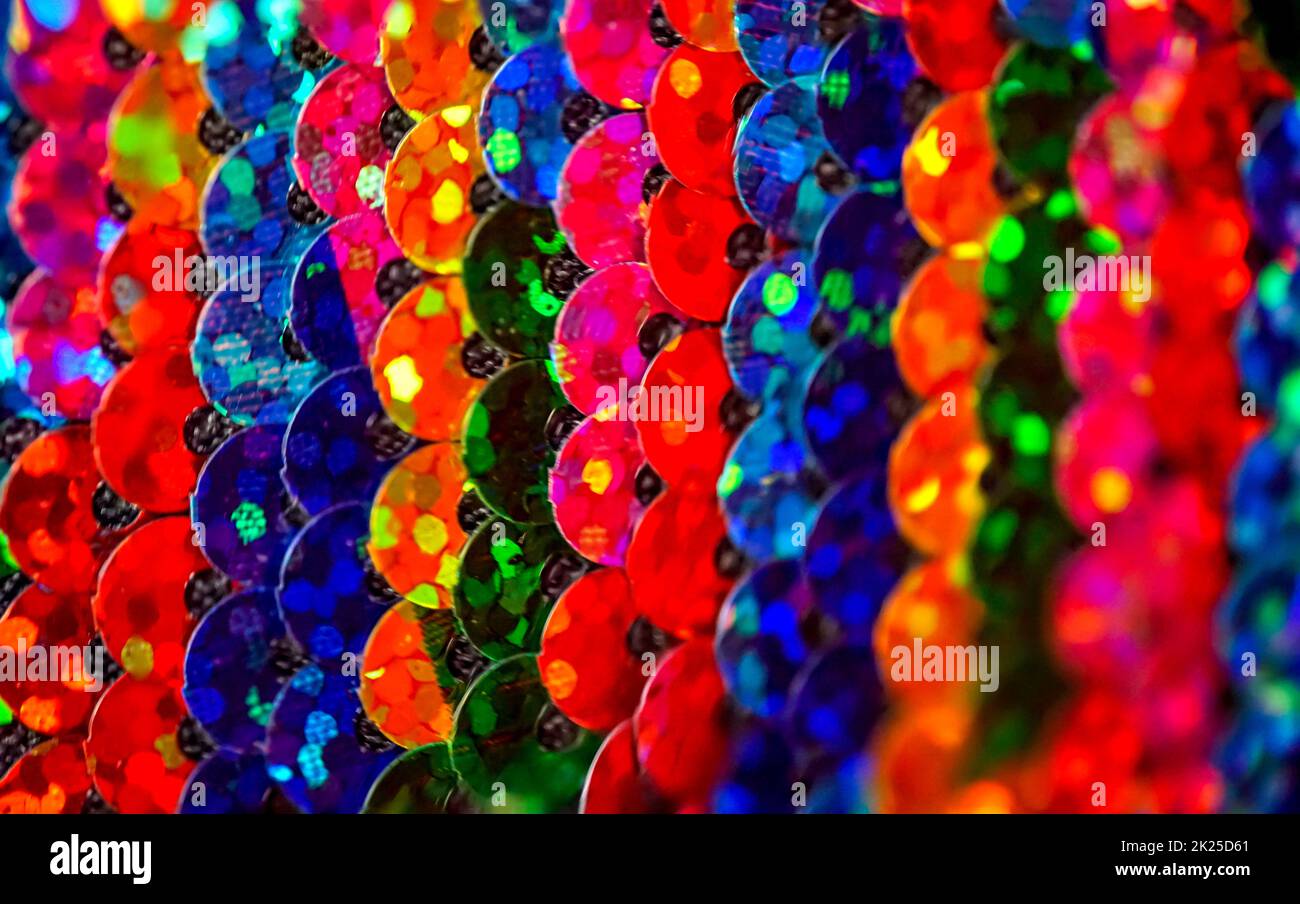 Colorful sequins sewn onto a garment reflect, glow in the light Stock ...