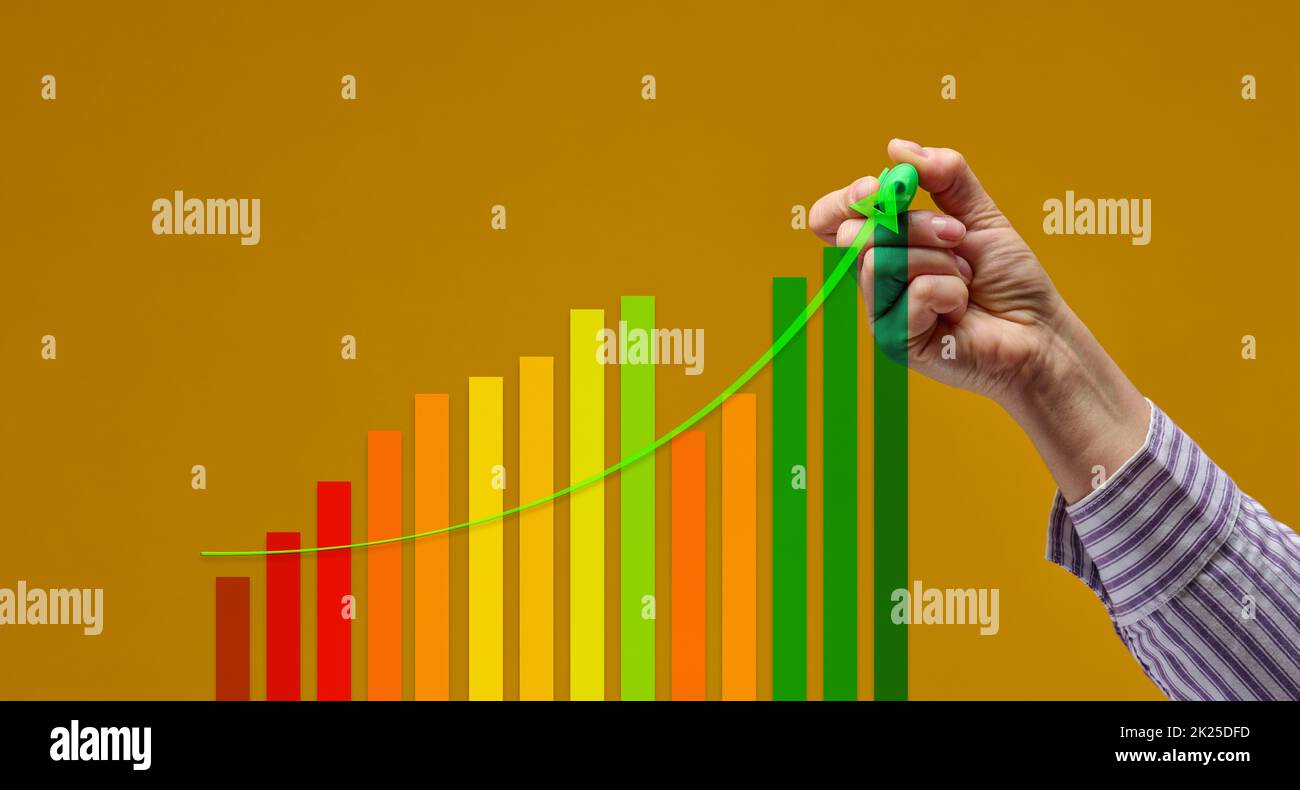 female hand with green marker and multicolored graph on yellow ...