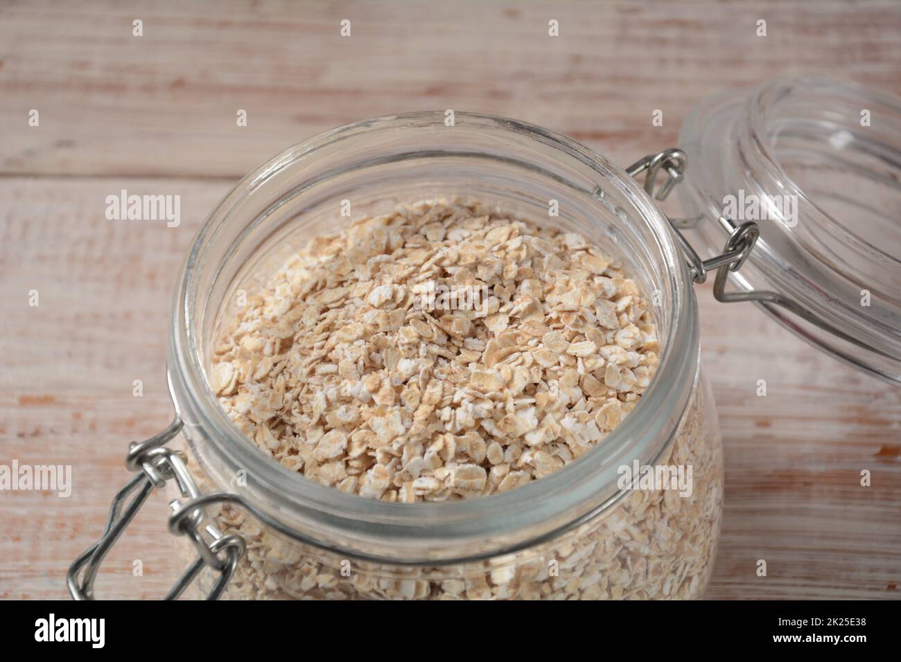 Uncooked oatmeal in a bowl on the table. Dehusked, hulled oats, rolled ...