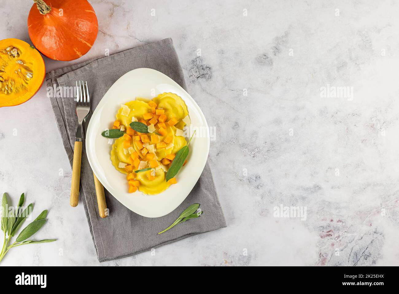 Seasonal autumn recipe. Pumpkin ravioli with sage, parmesan, and olive ...