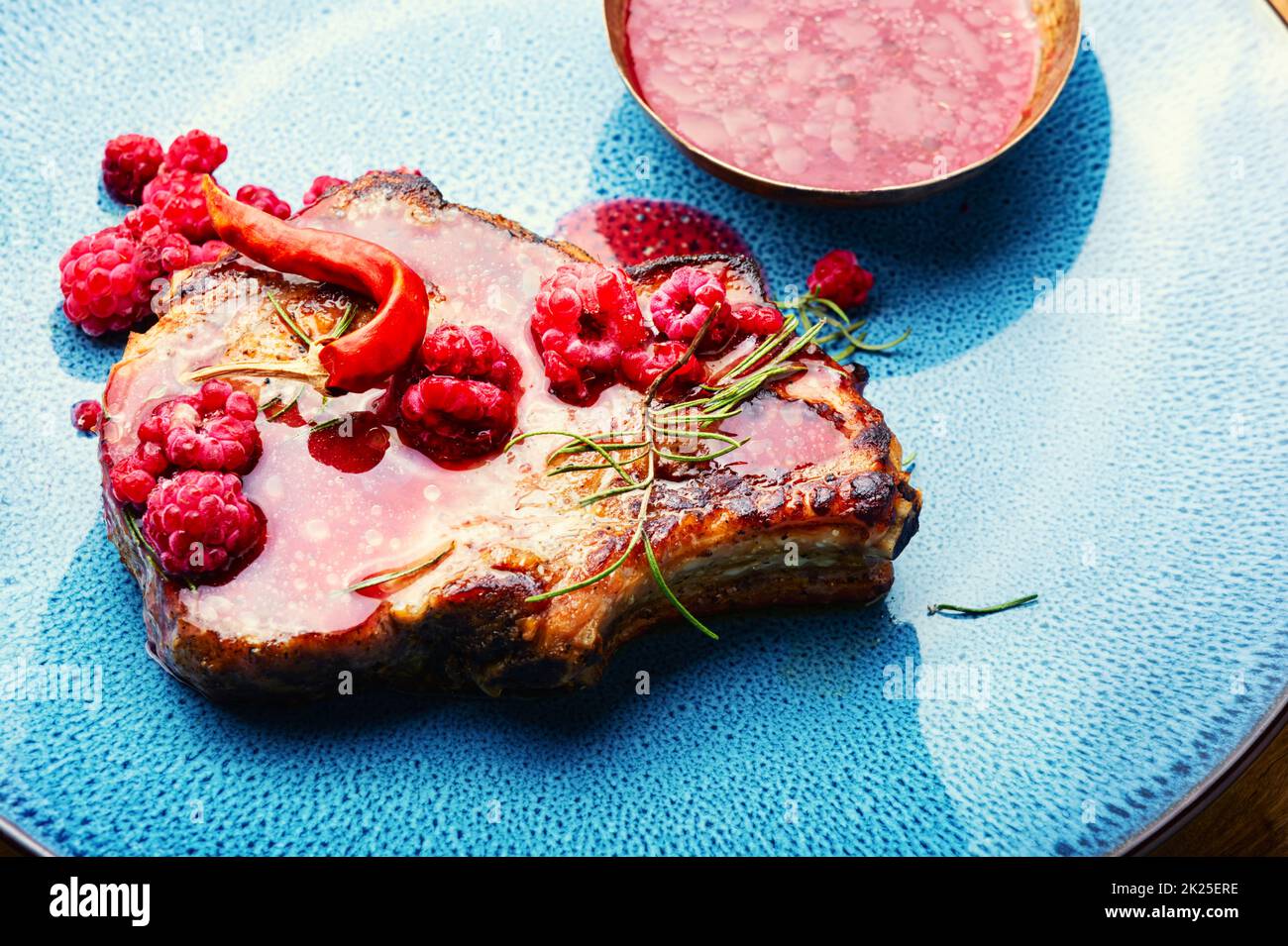 Fried steak with raspberry sauce Stock Photo - Alamy