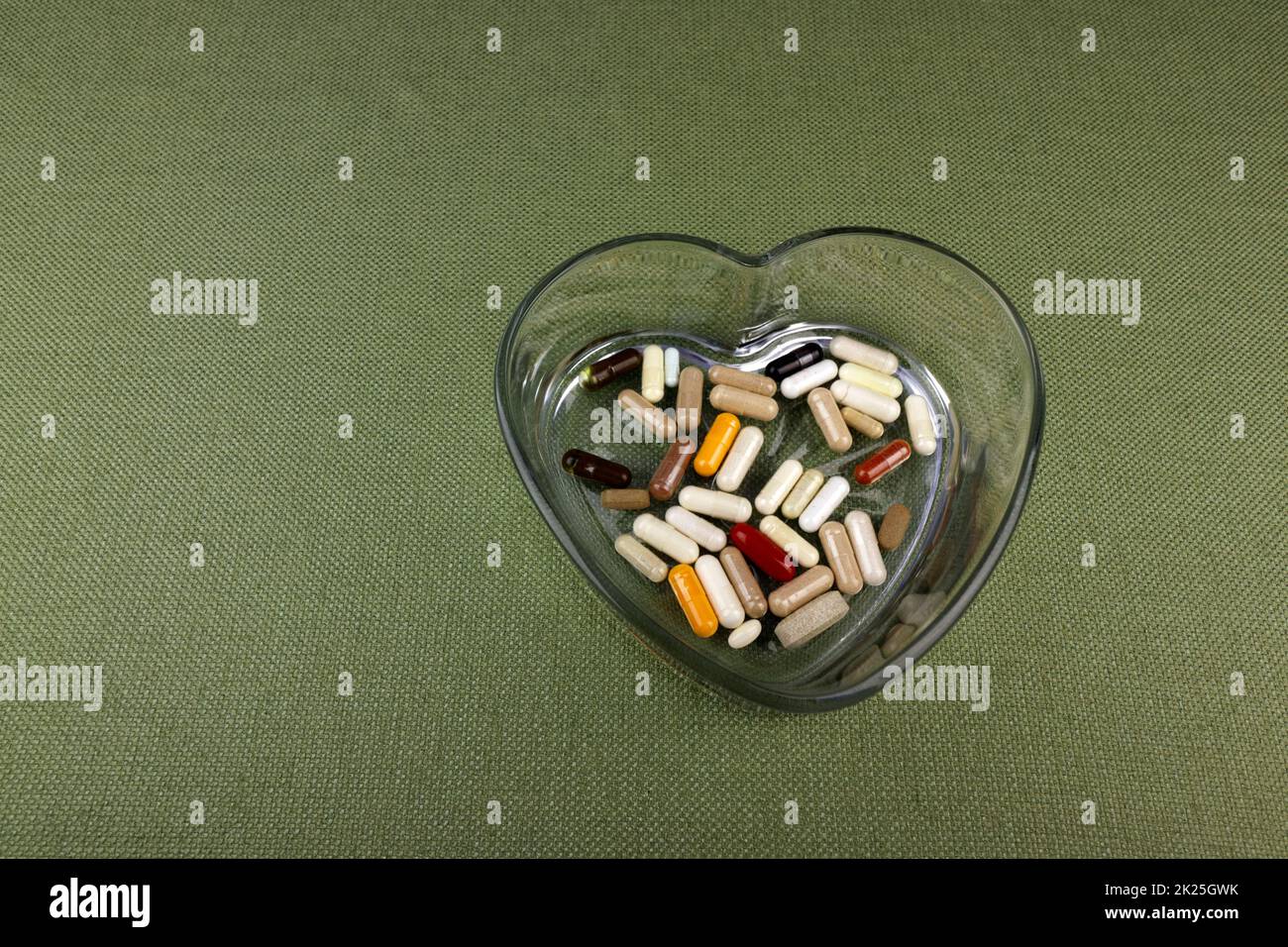 Nutritional Supplements in a Heart Shape Clear Glass Dish Stock Photo ...