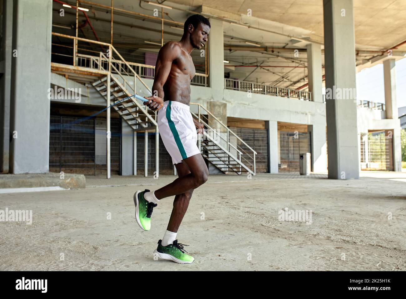 Black young sportsman working out with jumping rope outdoors Stock ...
