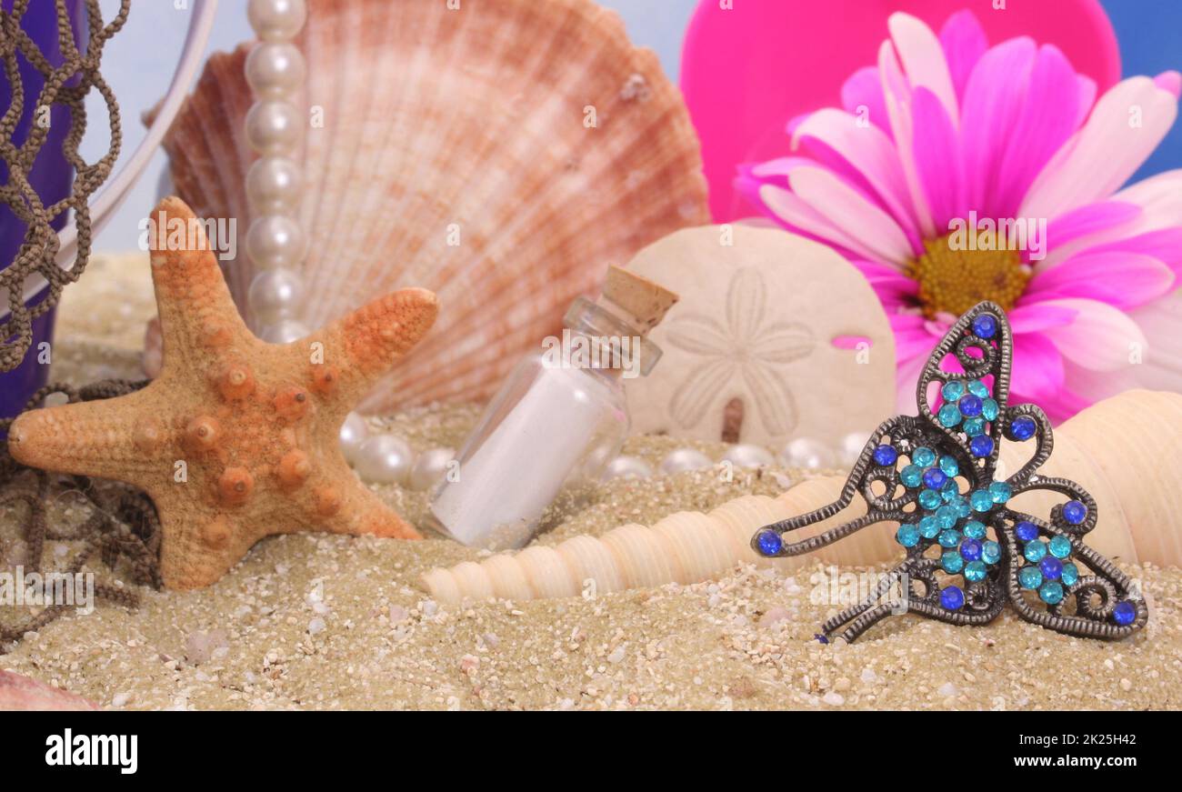 Sea Shells With Flower and Jewelry on Sandy Beach Stock Photo - Alamy