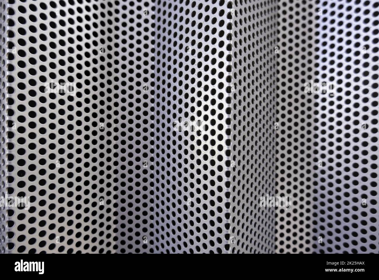 Metal wall with holes Stock Photo - Alamy