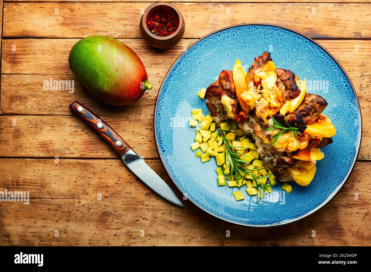 Baked meat with mango Stock Photo - Alamy