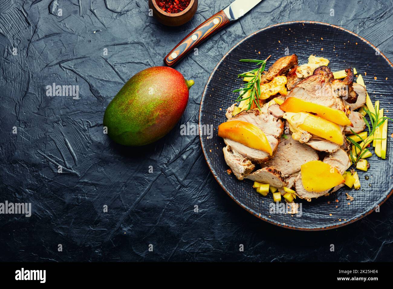 Baked meat with mango Stock Photo - Alamy