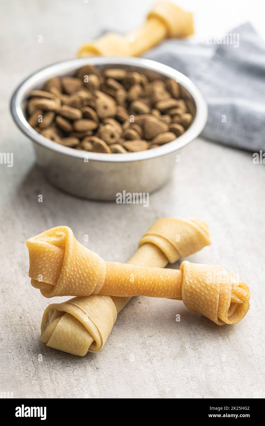 Delicacy for dogs. Chewing bone and dried food for dog Stock Photo - Alamy