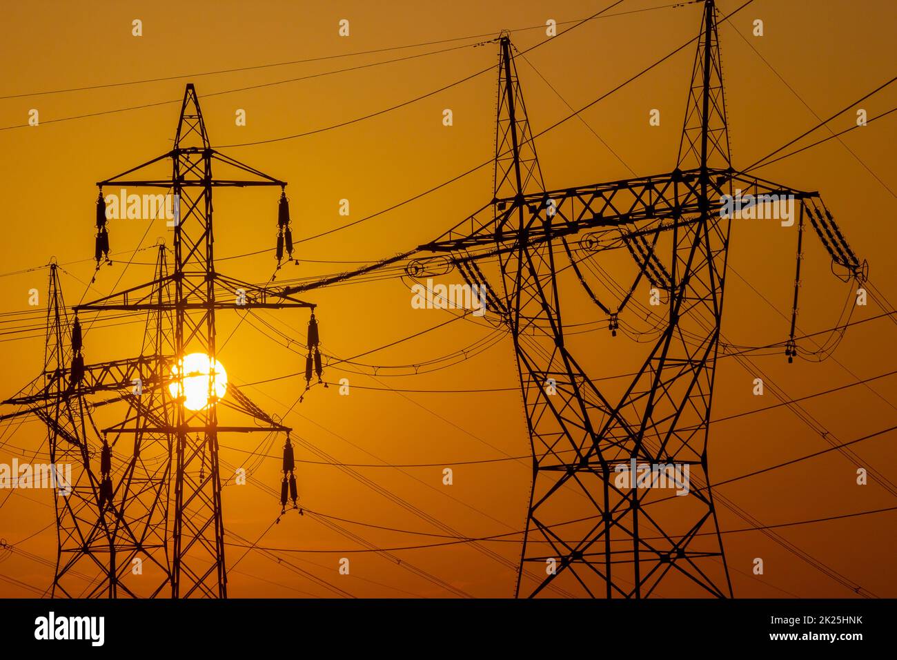 Transmission towers on sunset sky Stock Photo - Alamy