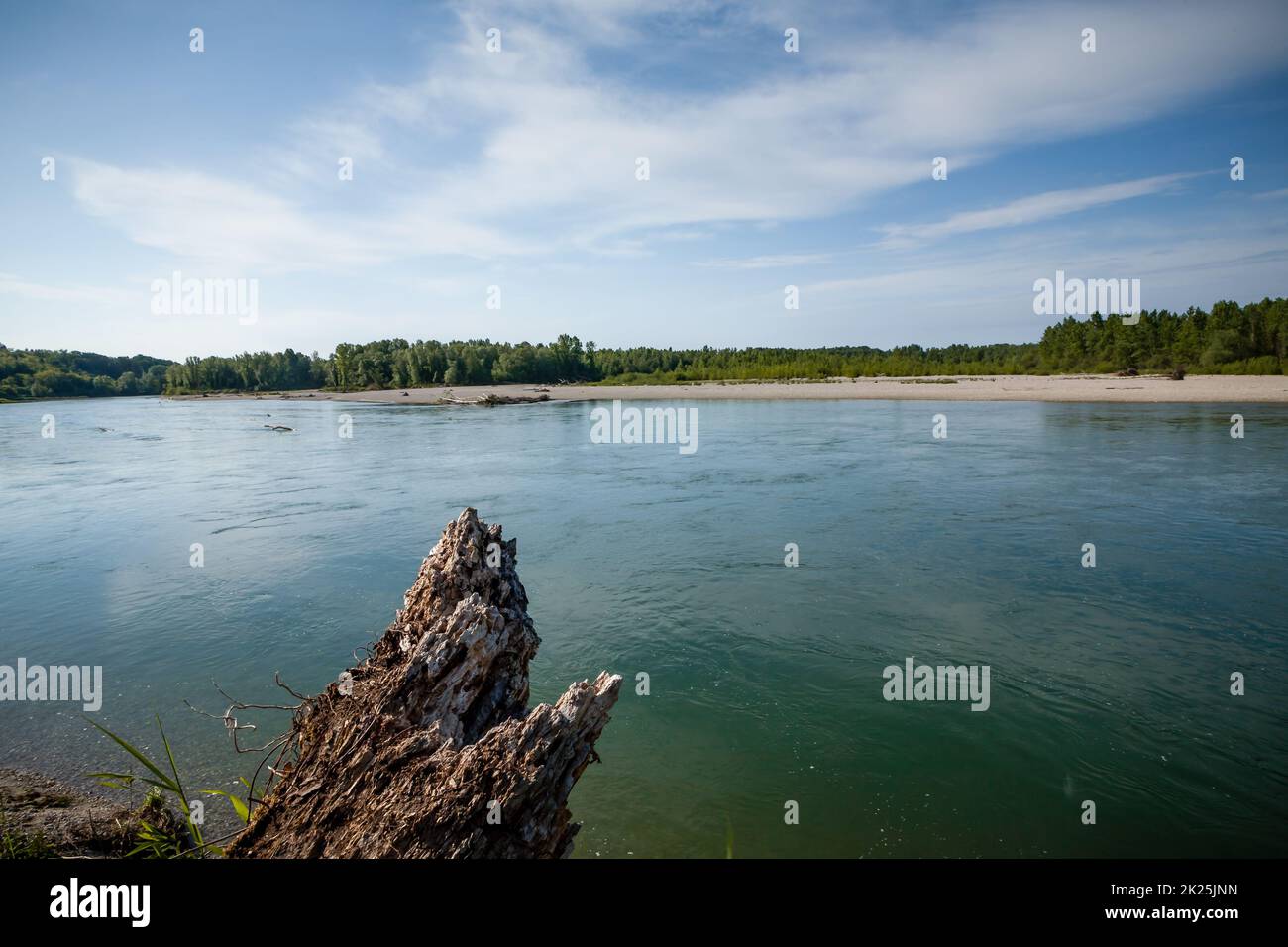 A beautiful shot of a reflective lake in a green landscape on a blue ...