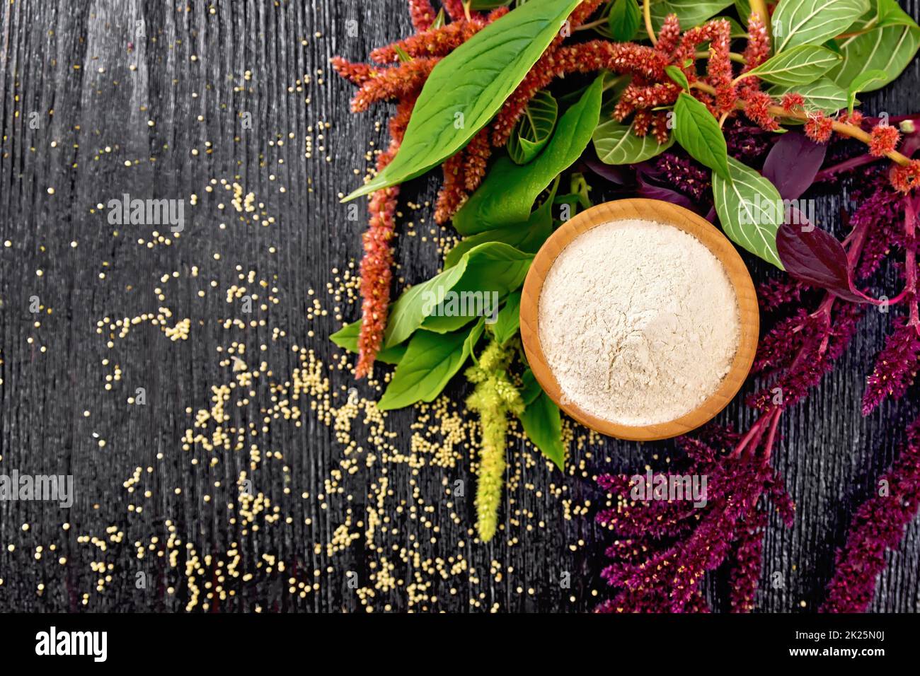 Flour amaranth in bowl and oil on board top Stock Photo - Alamy