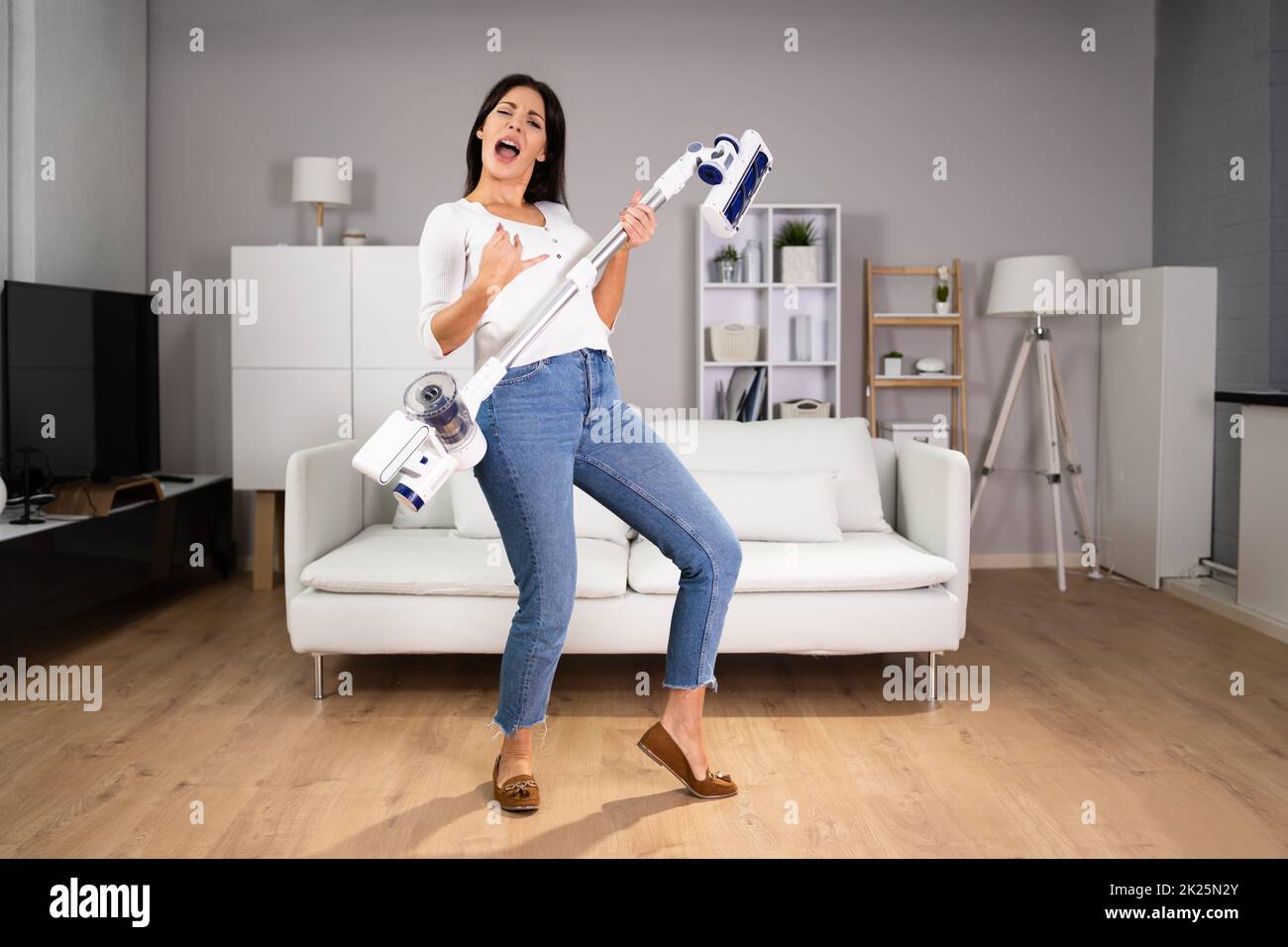 Happy Female Dancing And having Fun With Vacuum Cleaner Stock Photo - Alamy