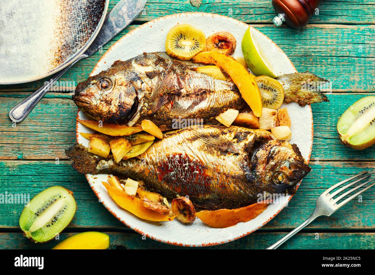 Baked gilthead fish in fruit Stock Photo - Alamy