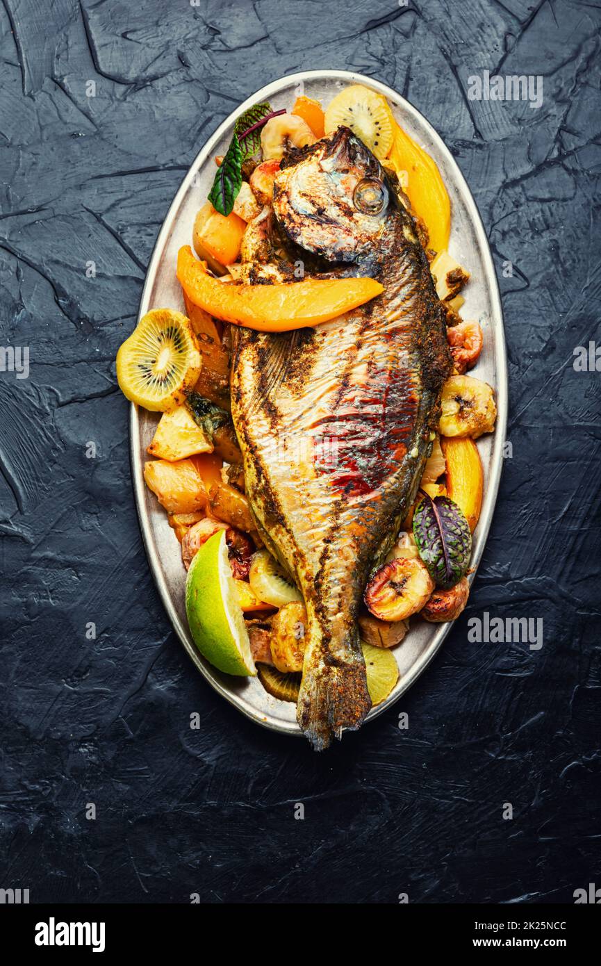 Baked gilthead fish in fruit Stock Photo - Alamy