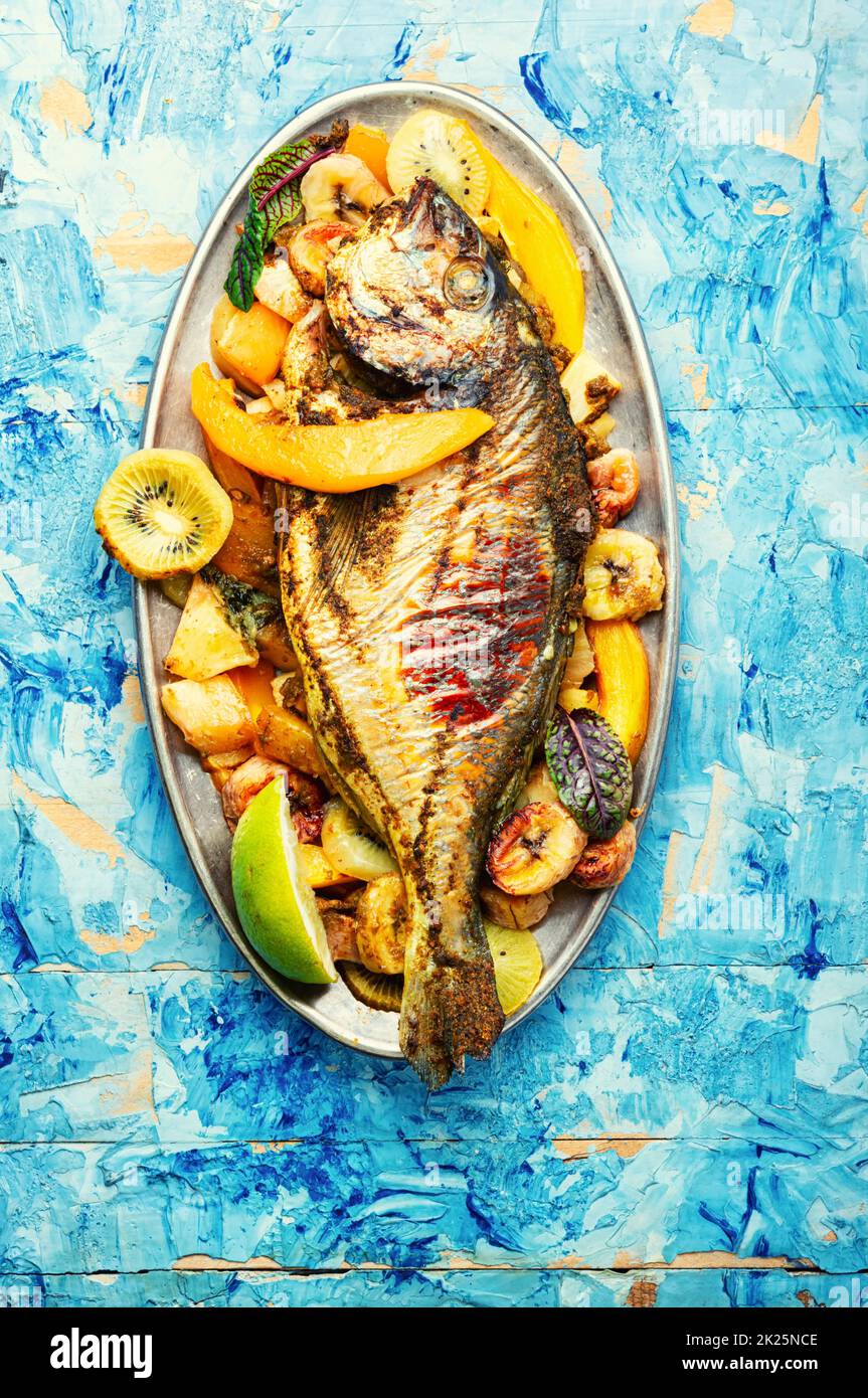Baked gilthead fish in fruit Stock Photo - Alamy