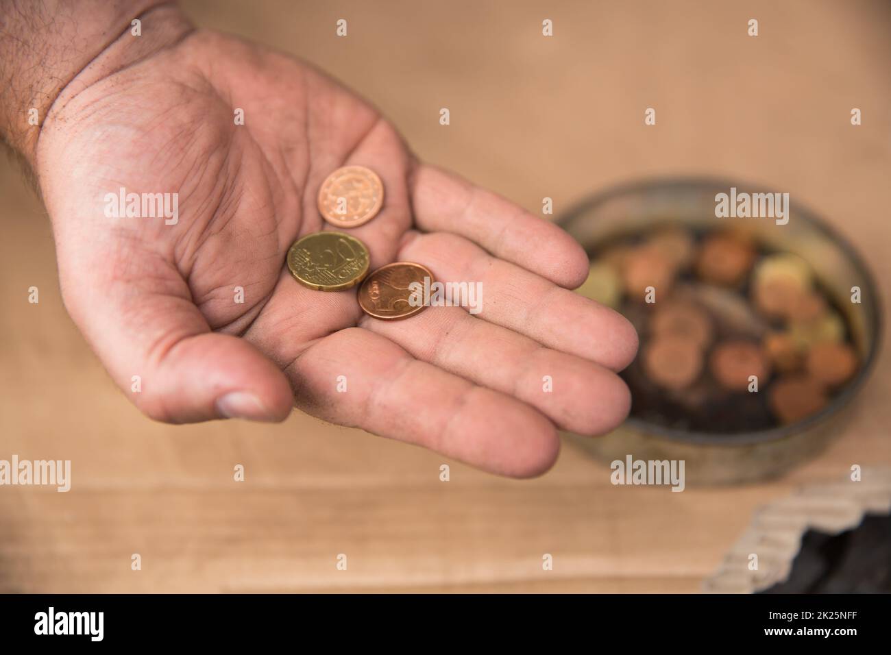 Beggar holds out his hand Stock Photo - Alamy