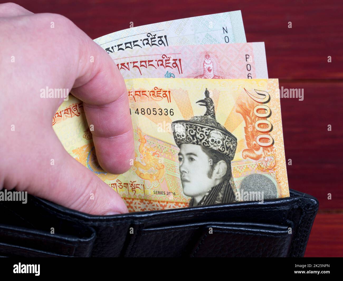 Bhutanese money in the black wallet Stock Photo - Alamy