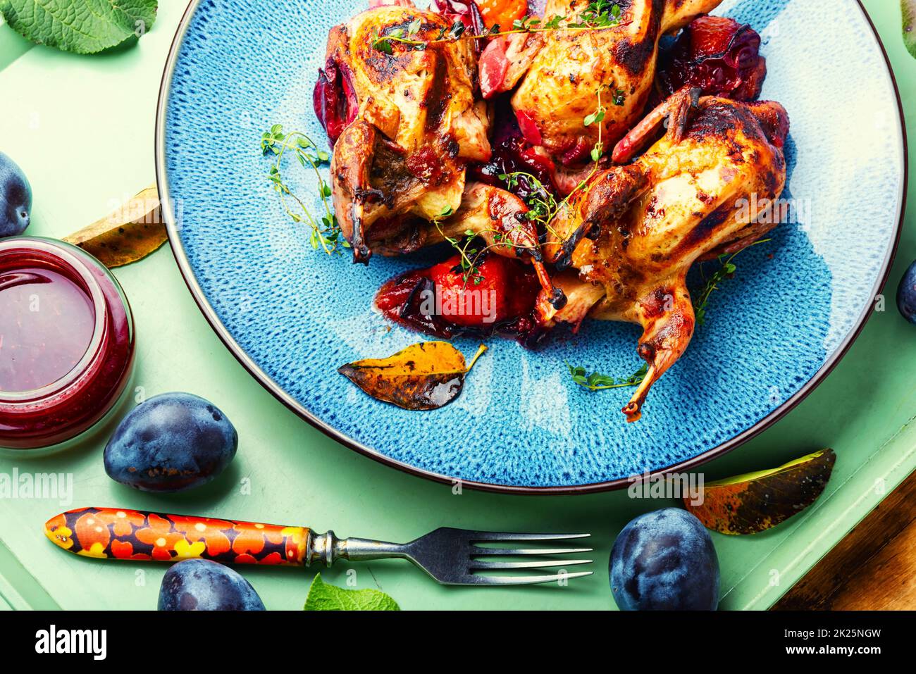 Quail stuffed with plums Stock Photo - Alamy