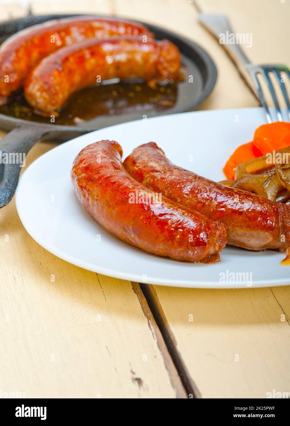 beef sausages cooked on iron skillet Stock Photo - Alamy