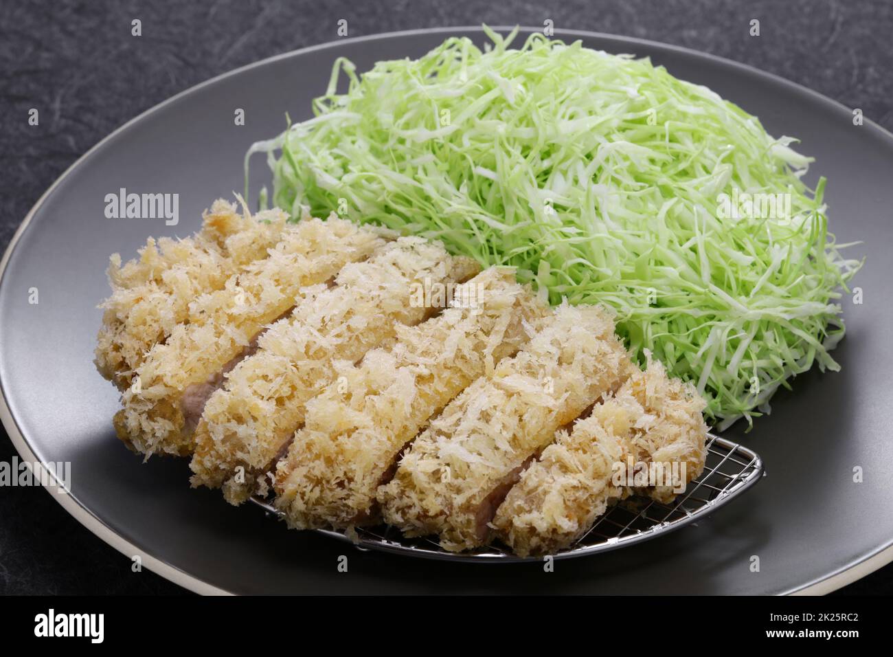 White Tonkatsu Pork Loin Cutlet Coated In Bread Crumbs And Deep Fried At A Low Temperature