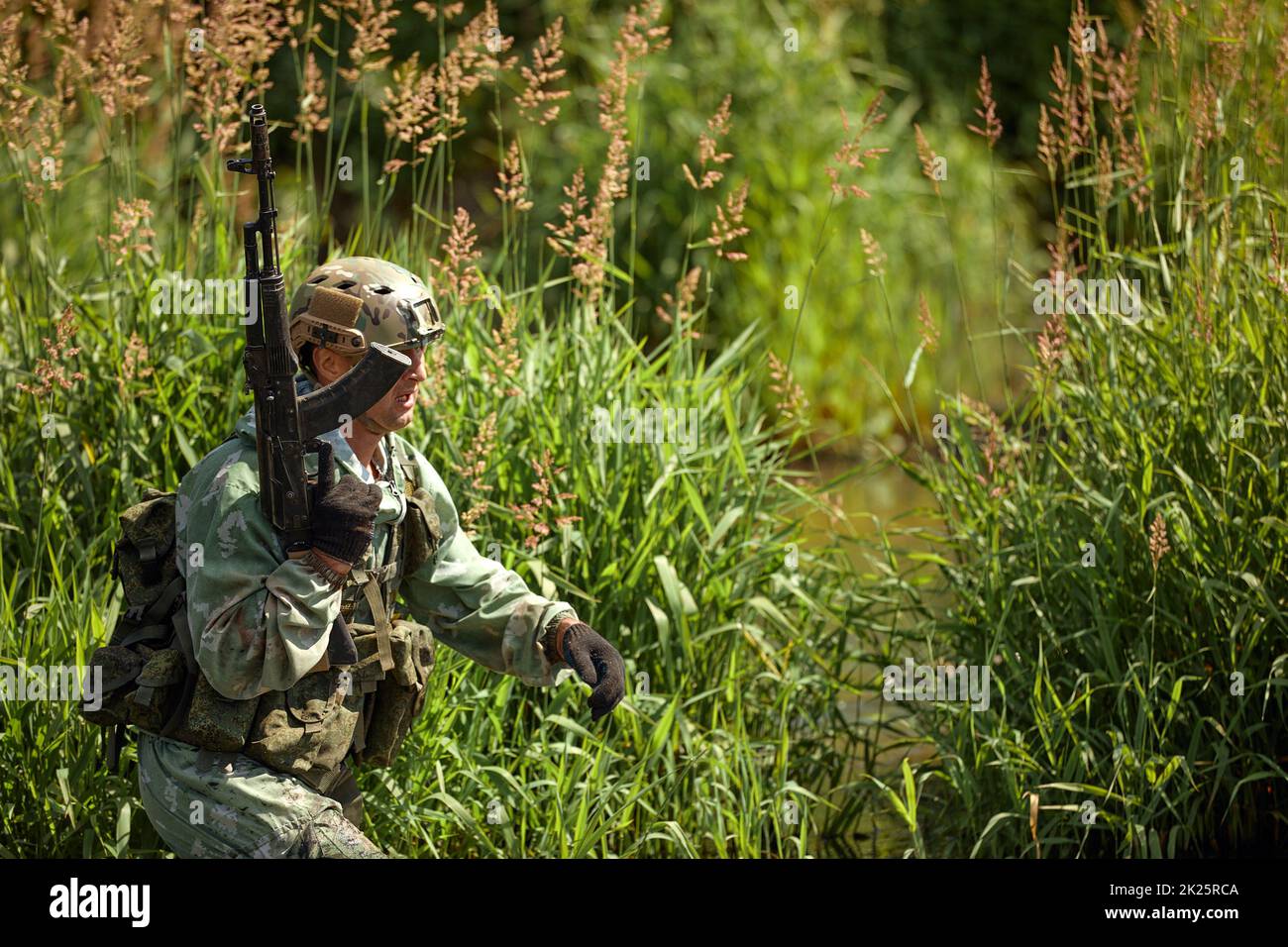Special forces soldier with weapon take part in military maneuver. War ...