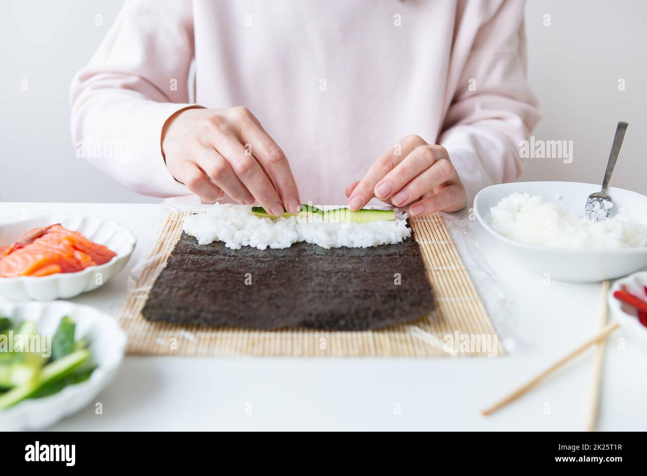 Sushi cooking process, girl makes sushi with different flavors Stock ...