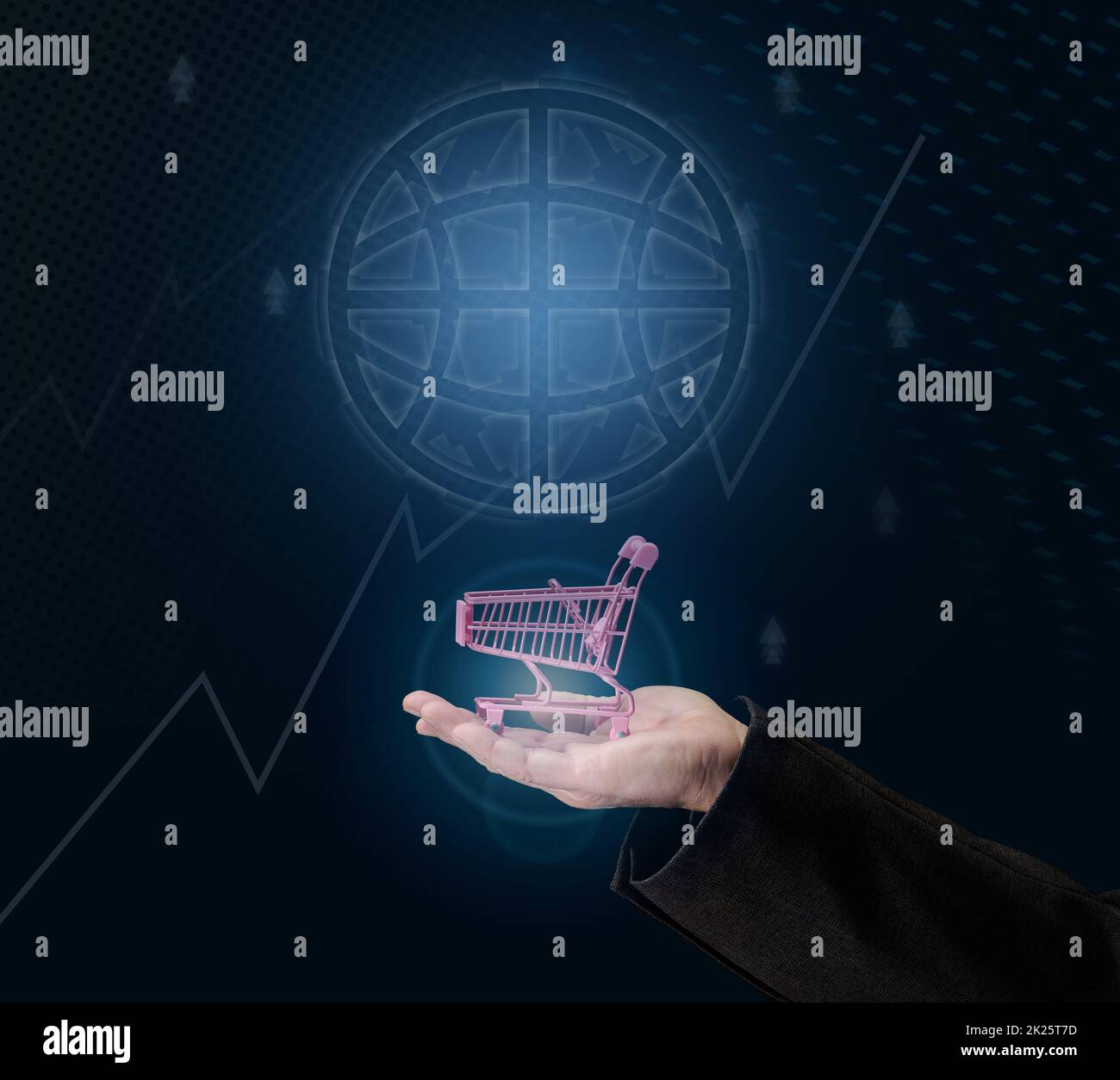 a man's hand holds a miniature shopping cart on a dark blue background ...