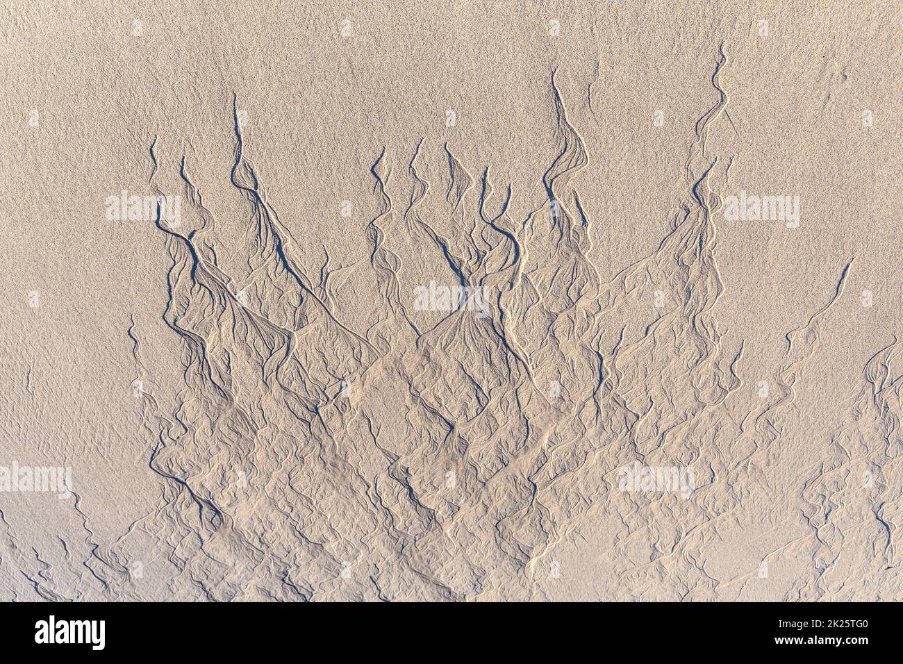 islamic pattern type texture on the sand beach while low tide time ...