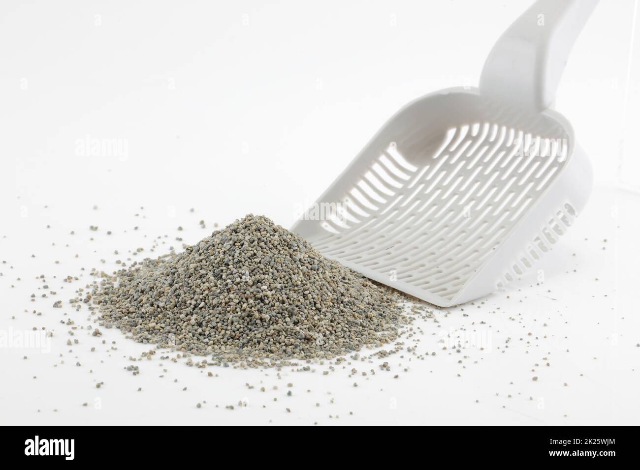 Scoop and heap of cat litter isolated on white Stock Photo - Alamy