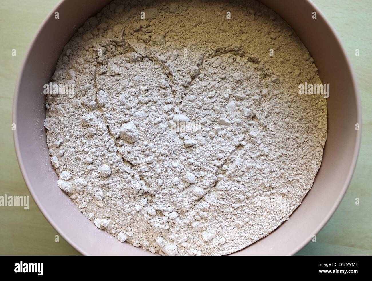 Fresh wheat flour with a heart painted into it in a light bowl taken ...