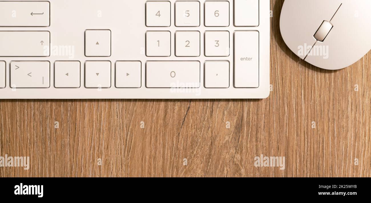 Keyboard from a computer and a computer mouse on a desk in the office ...