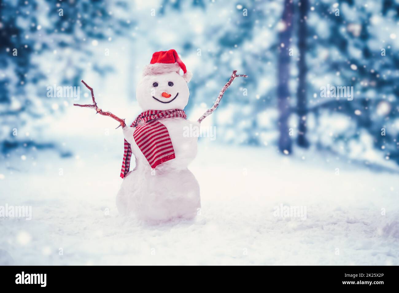 Cheerful snowman with orange scarf and in yellow boots stands upside ...