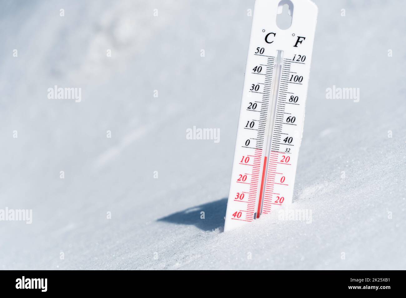 The thermometer lies on the snow in winter showing a negative ...