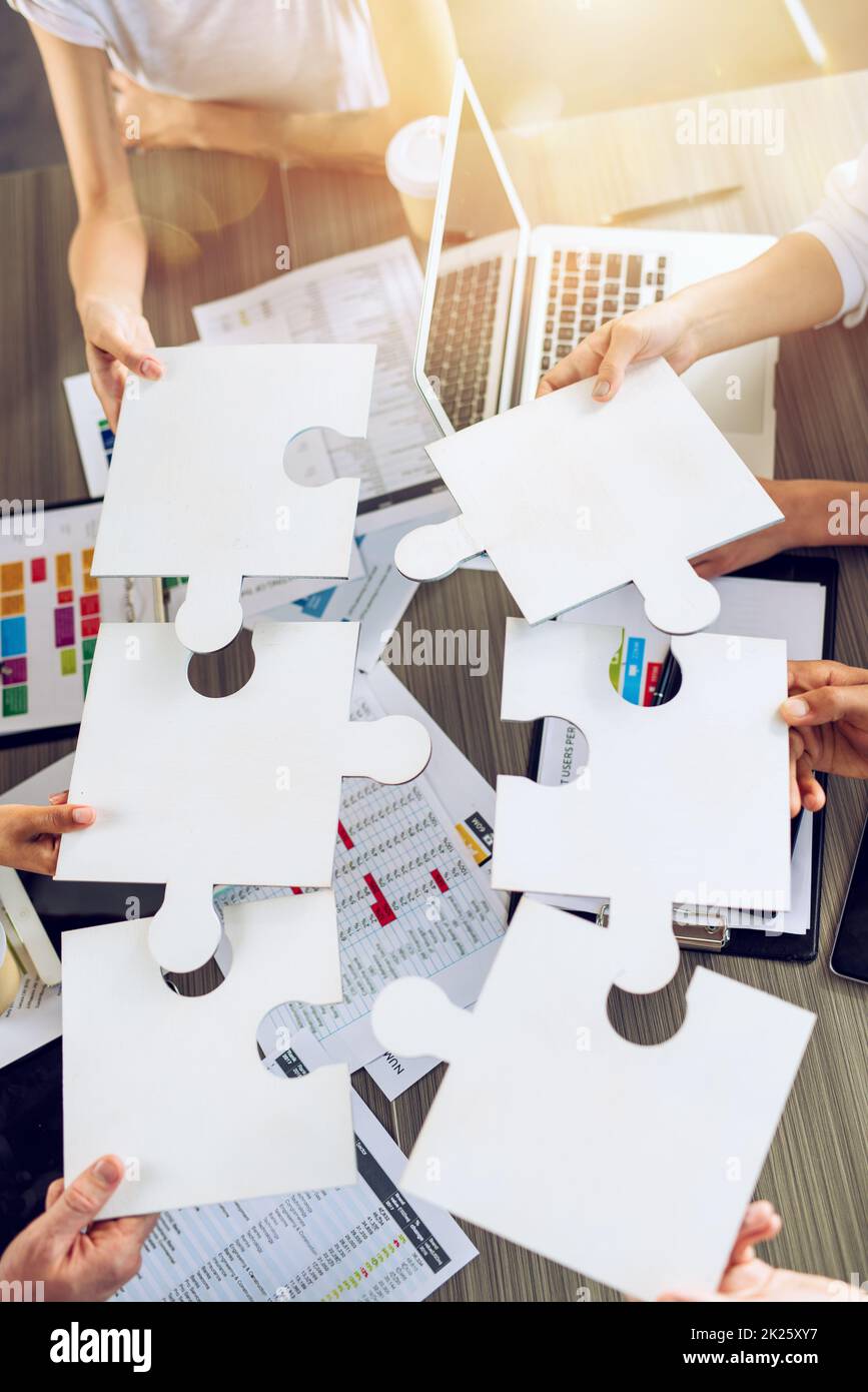 Teamwork of partners connect puzzle pieces as integration and startup ...