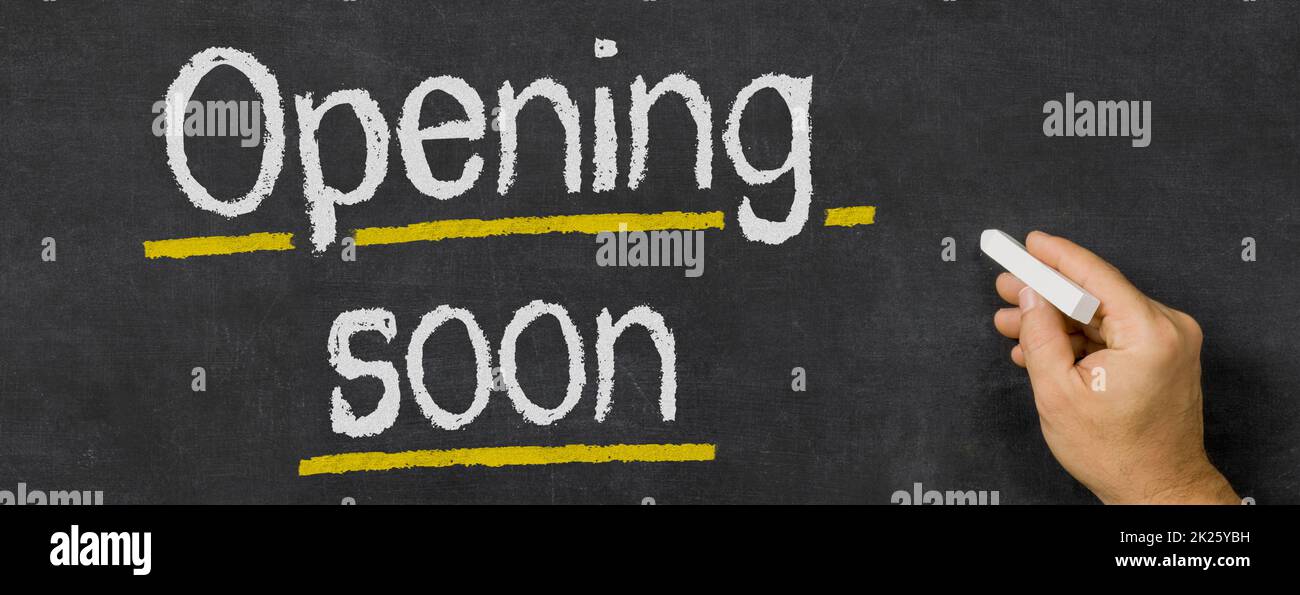 Text written on a blackboard - Opening soon Stock Photo - Alamy
