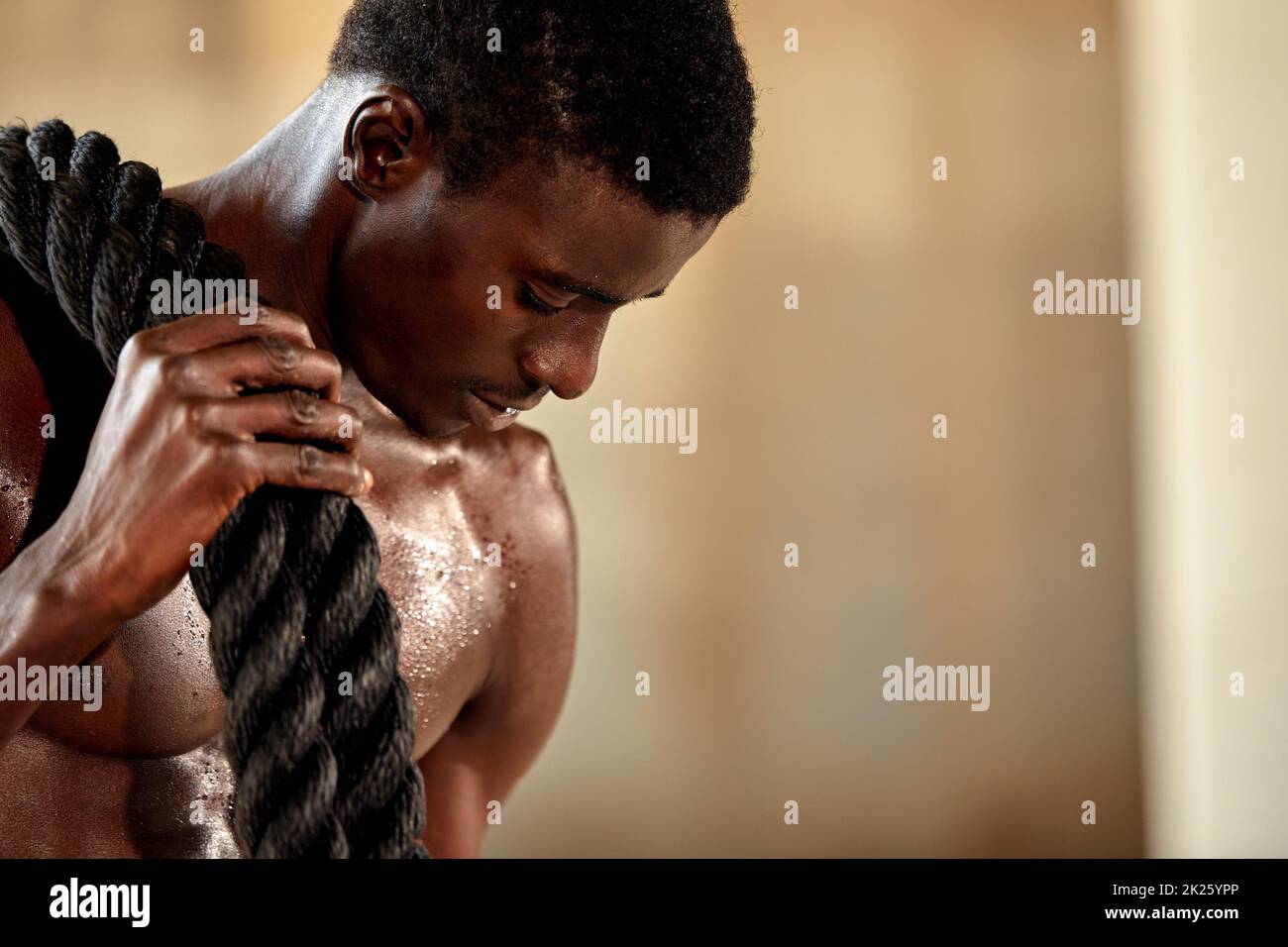 Rope workout. Sport man doing battle ropes exercise outdoor. Black male ...