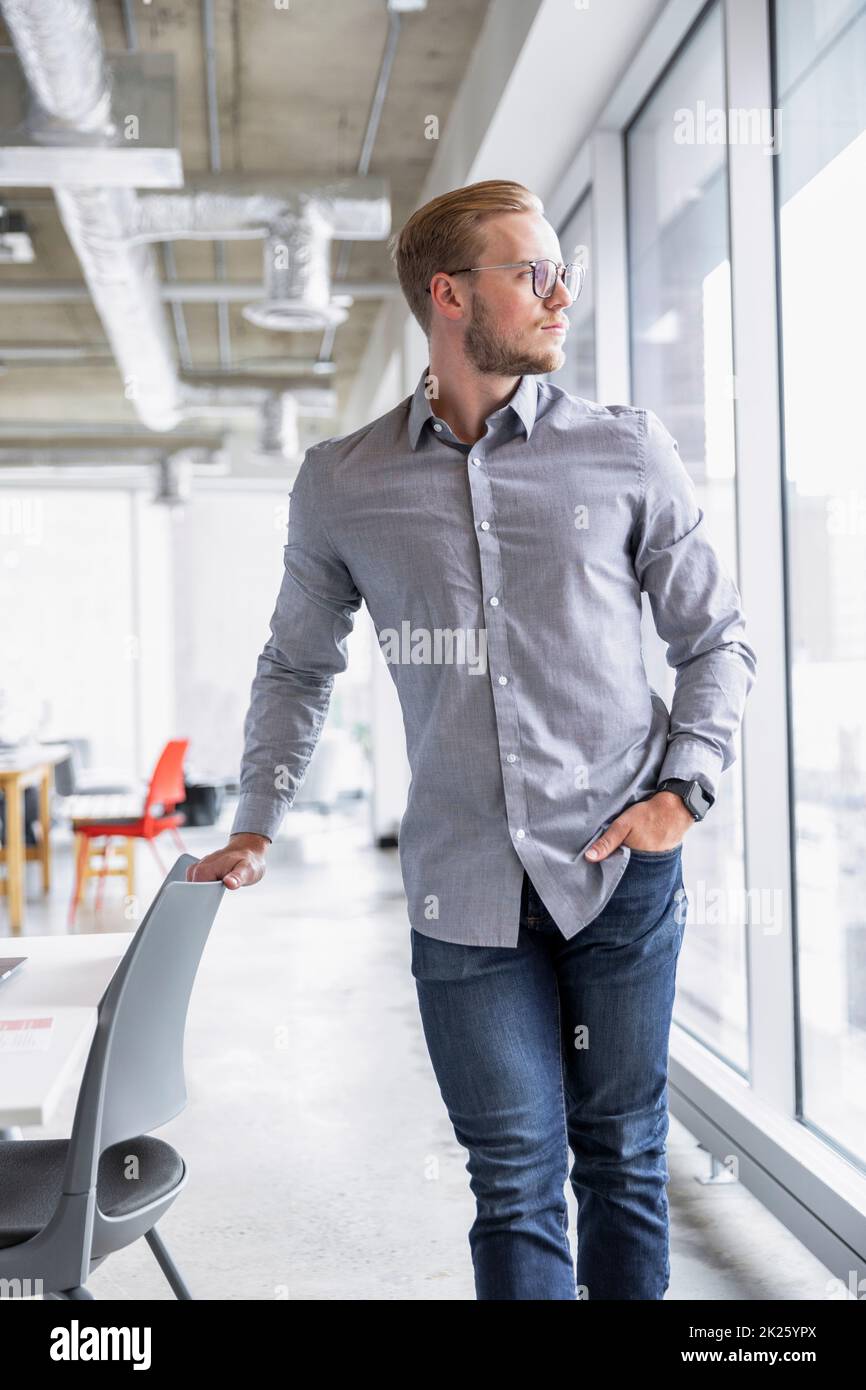 Man standing by the window hi-res stock photography and images - Alamy