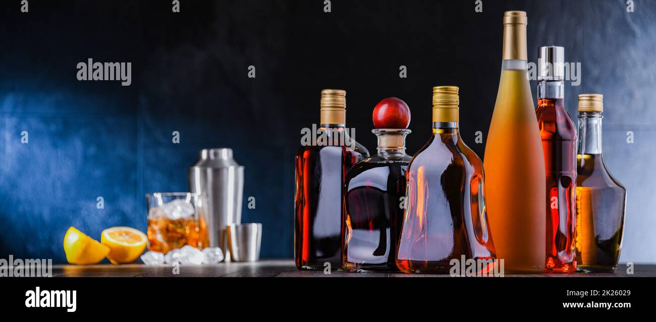 Bottles of assorted alcoholic beverages and bartender Stock Photo - Alamy