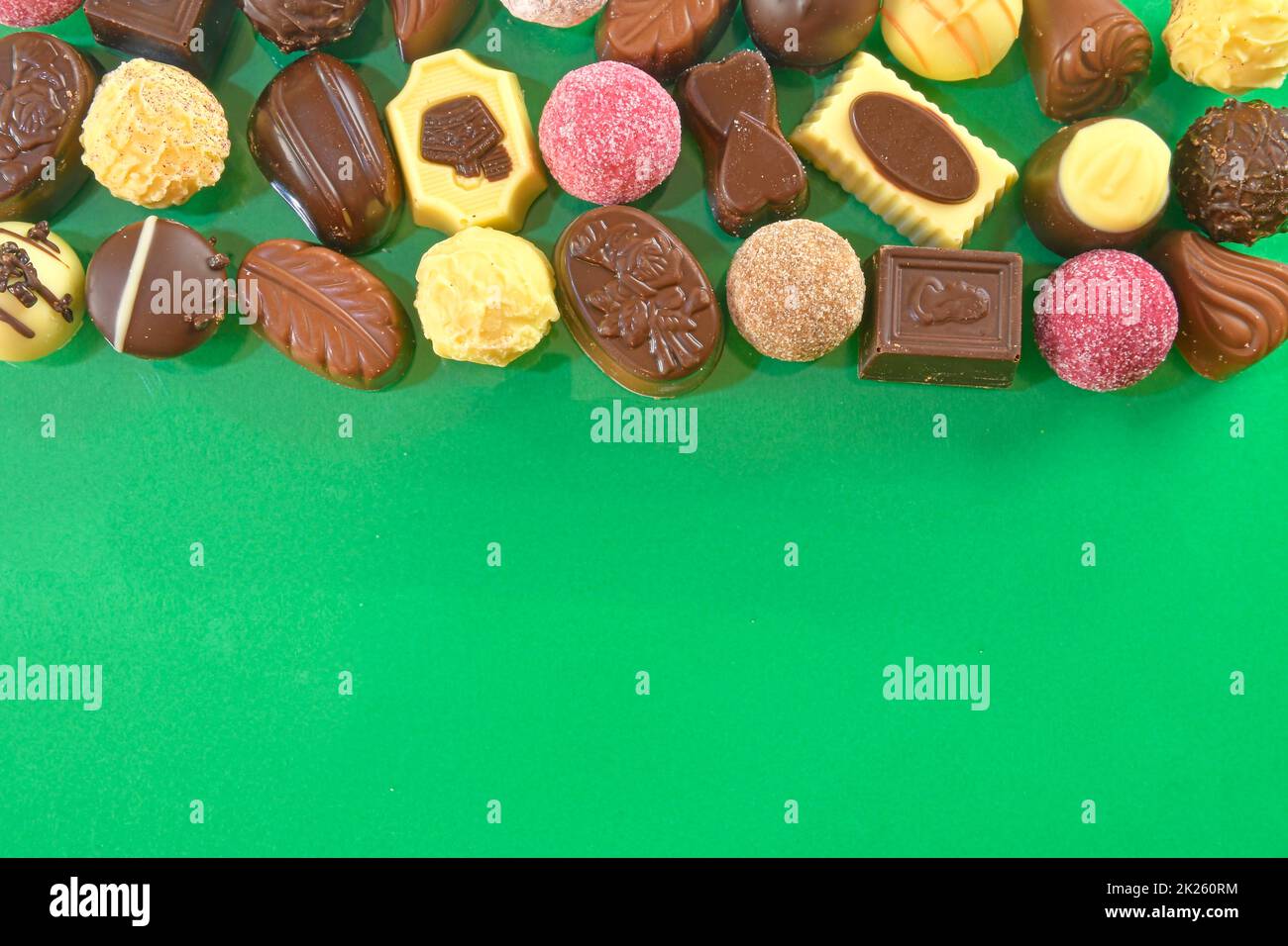 Chocolate pralines frame top view stock images. Chocolate candies on a ...